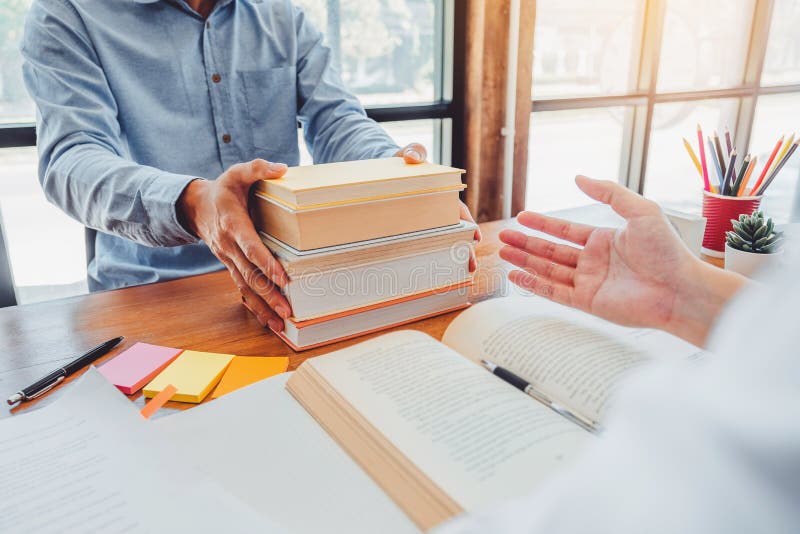 High School or College Students Studying and Reading Together in ...