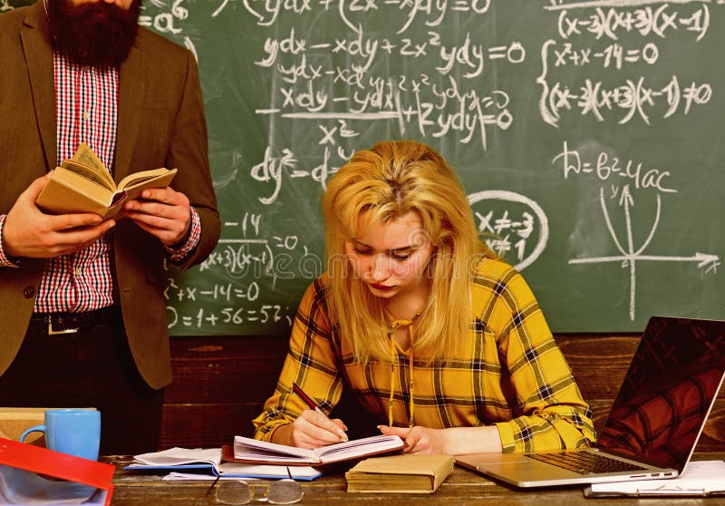 High School or College Students Studying and Reading Together in ...