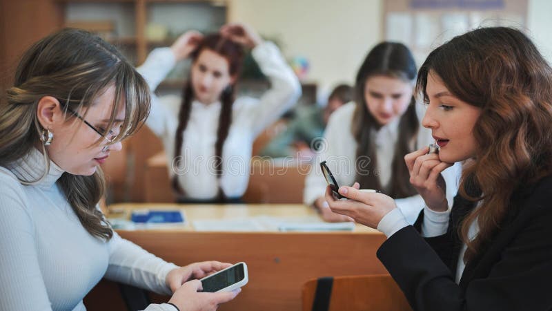High School Girls at a Desk in the Classroom between Classes. Stock ...