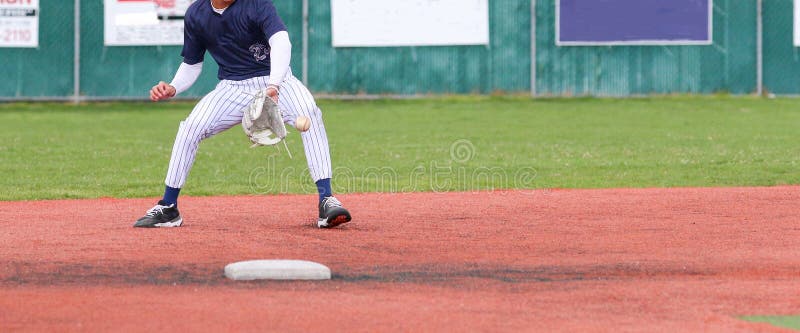 Baseball Second Baseman Backhanding a Ground Ball during a Game Stock ...
