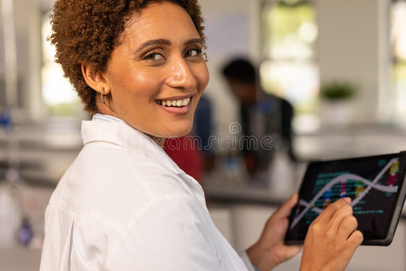 In High School, Smiling Teacher Using Tablet To Study DNA Structure in Science Lab Stock Photo ...