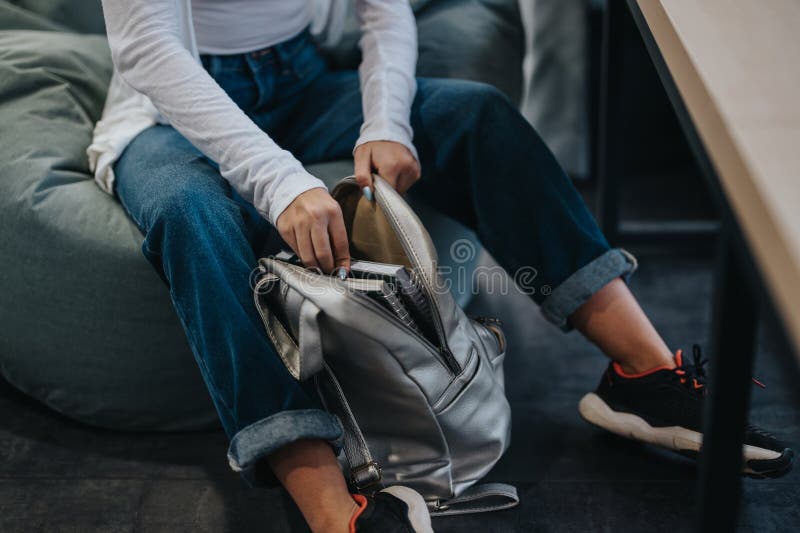 High School Student Packing Books into a Backpack in Study Area Stock ...