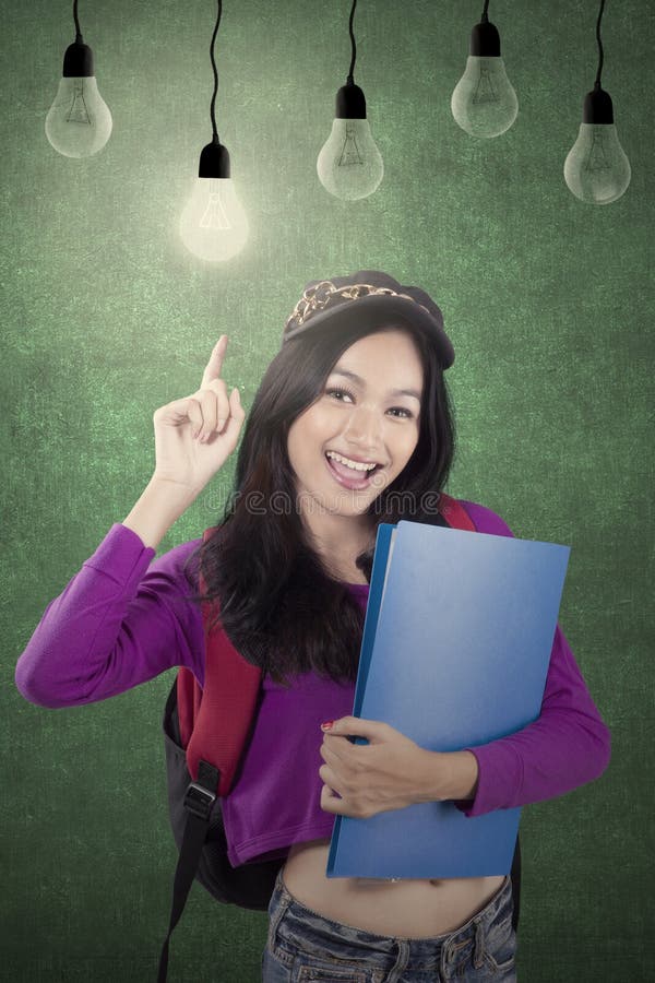 High School Student Pointing at a Light Bulb Stock Photo - Image of ...