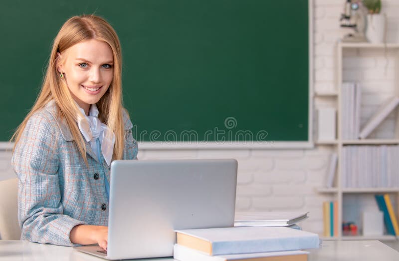 High School Student Sitting at Table and Writing on Notebook, Learning ...