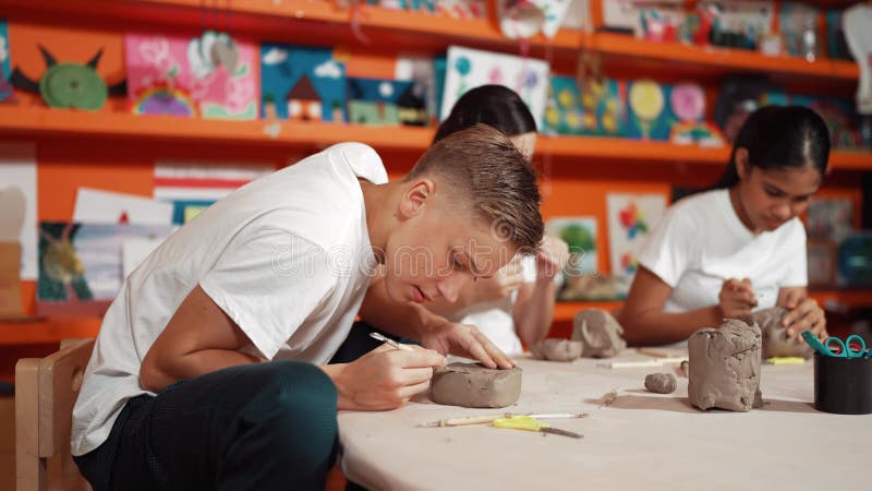 Student Using Carving Tool Working at Clay at Pottery Workshop ...
