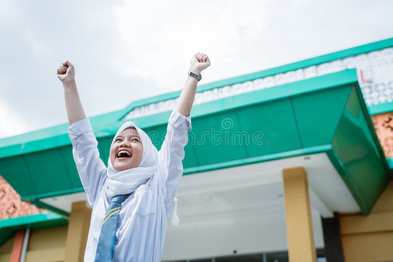 High School Student in a Veil Smiles Raising Hands with Copyspace Stock ...