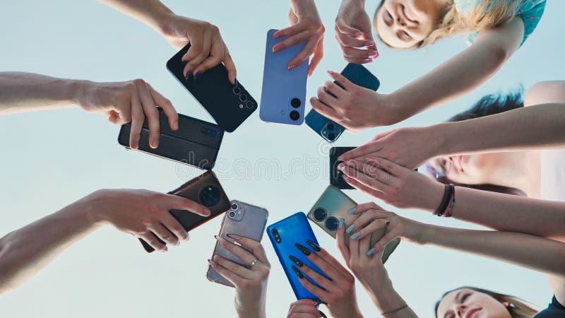High School Students in a Circle, Using Smartphones and Sharing Content ...