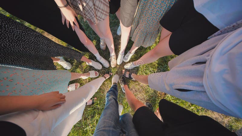 Group of High School Students Forming a Circle on Grass, Showing Unity ...