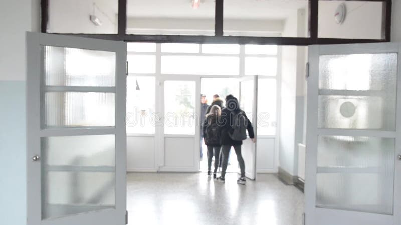 High School Students Entering a Classroom. Blurred Pupils Walking Down ...