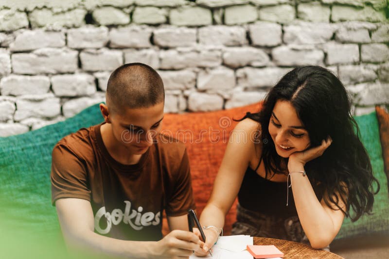 High School Students Gathering at a Cafe, Studying, Doing Homework, and ...