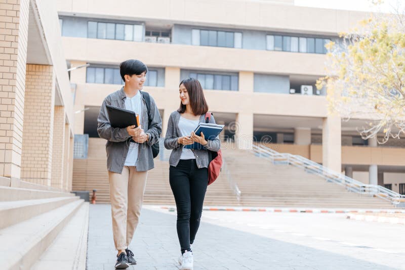 High School Students Hold Book and Laptop in the University. Education ...