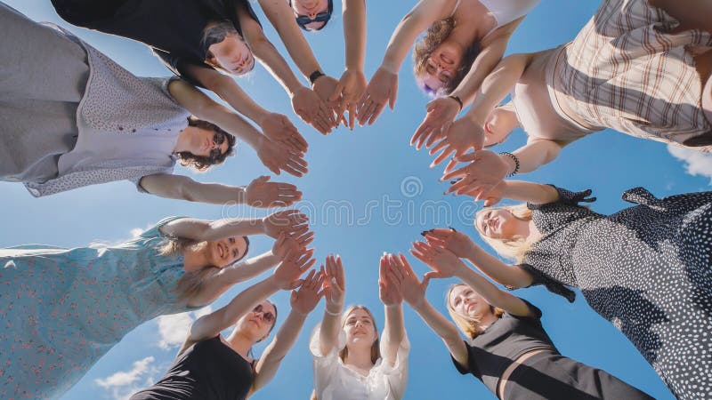 High School Students Joining Hands in a Circle Under the Clear Blue Sky ...