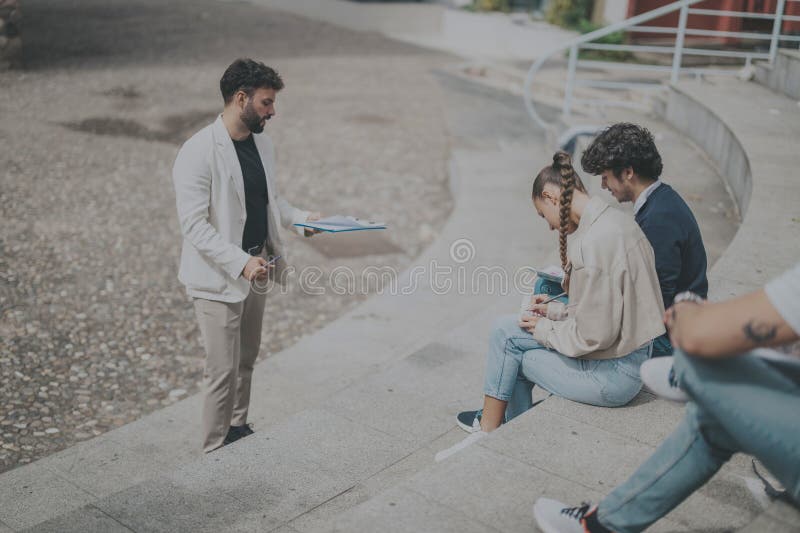 High School Students Receiving Help from Professor Outdoors Stock Photo ...
