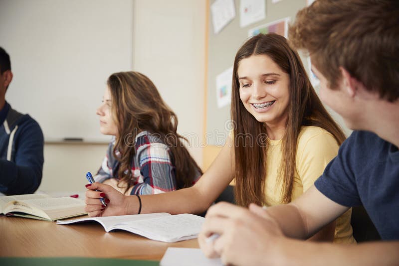 High School Students Sitting at Table Collaborating in Class Together ...