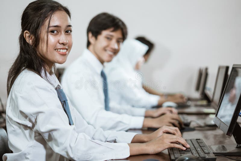 High School Students Smile while Using a Computer Pc with Their Friends ...