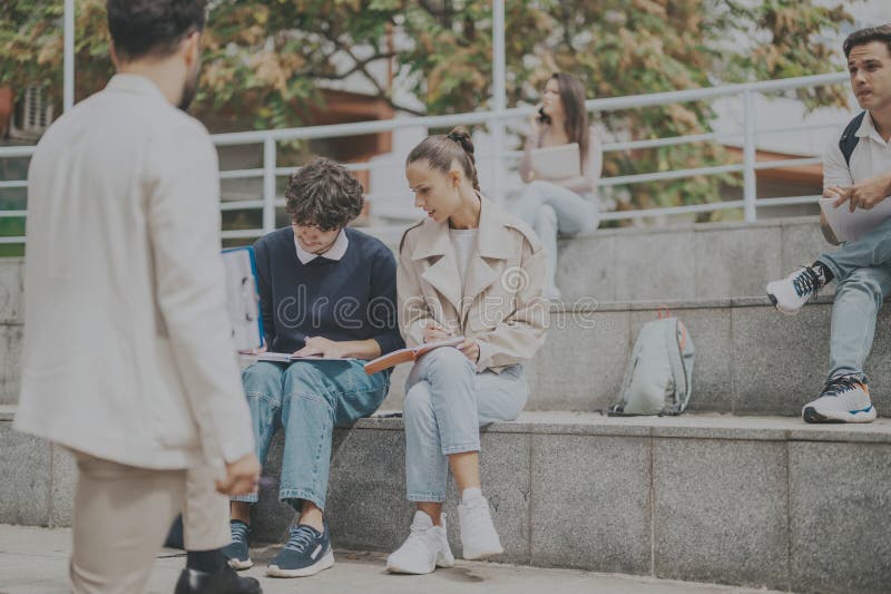 High School Students Studying Outdoors with Teacher& X27;s Assistance Stock Image - Image of ...
