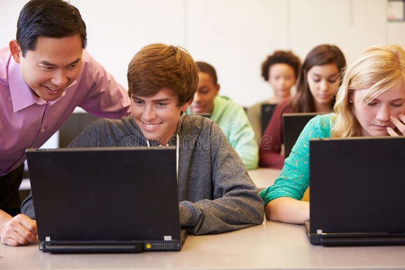 High School Students with Teacher in Class Using Laptops Stock Image ...