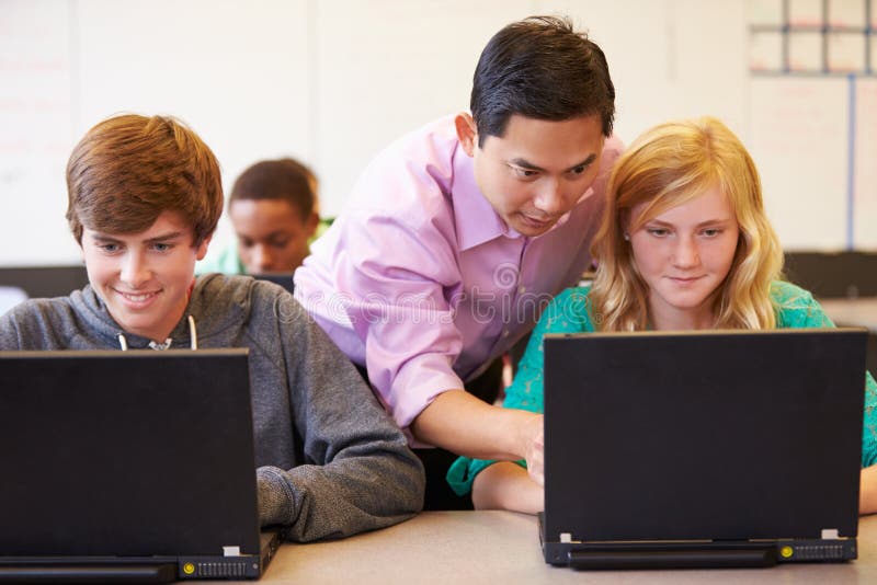High School Students with Teacher in Class Using Laptops Stock Photo ...