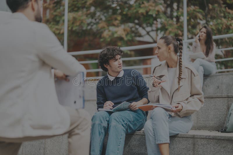High School Students Working with Professor Outdoors on Tasks Stock ...
