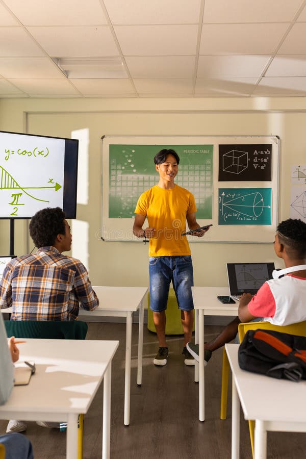 In High School, Teenage Boy Presenting in Classroom Using Tablet and Whiteboard Stock Photo ...