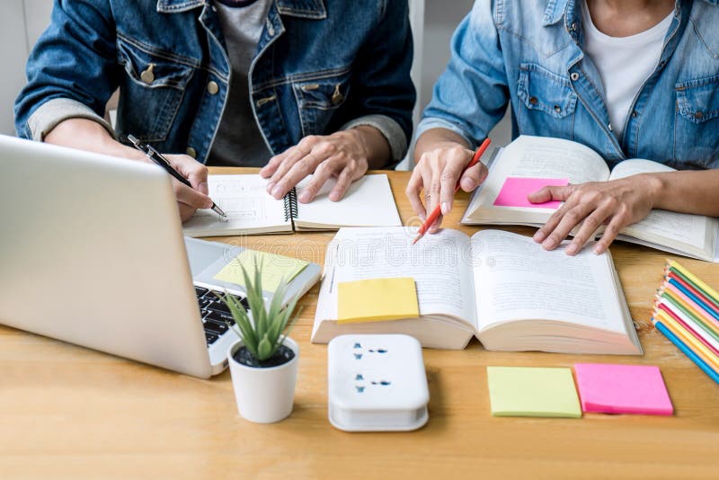 High School Tutor Or College Student Group Sitting At Desk In Library ...