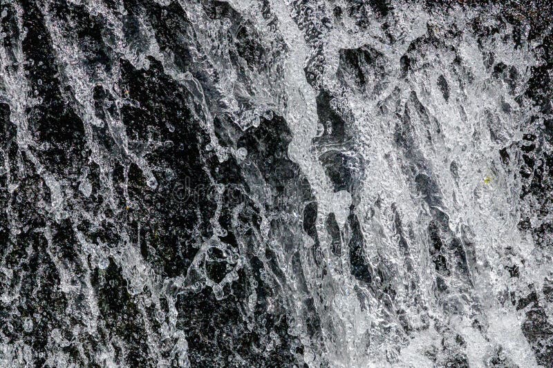 High Shutter Speed Photo of Water Flowing on a Rock Stock Image - Image ...