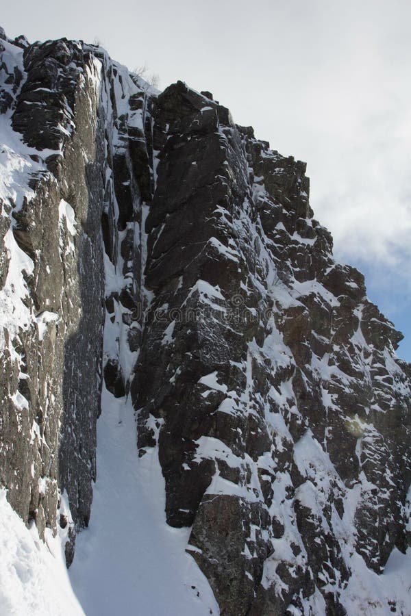 High snow covered rock stock photo. Image of peak, covered - 174070396