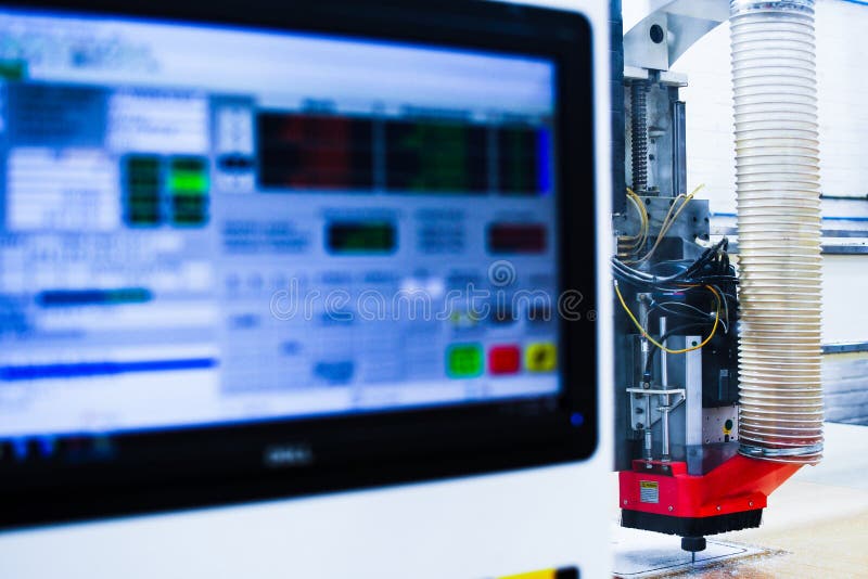 High Speed CNC Cutting Tool with Computer in Foreground Stock Photo ...
