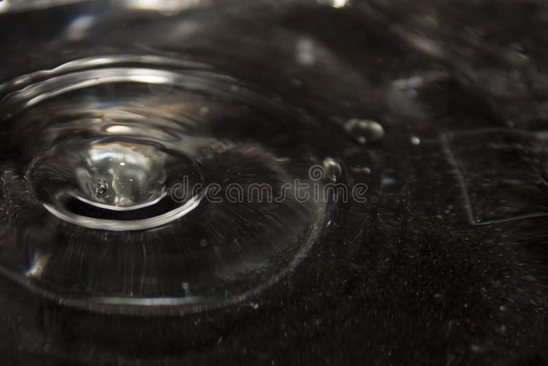 High Speed Frozen Splash of Liquid Emerging from Depth in Clean Water ...