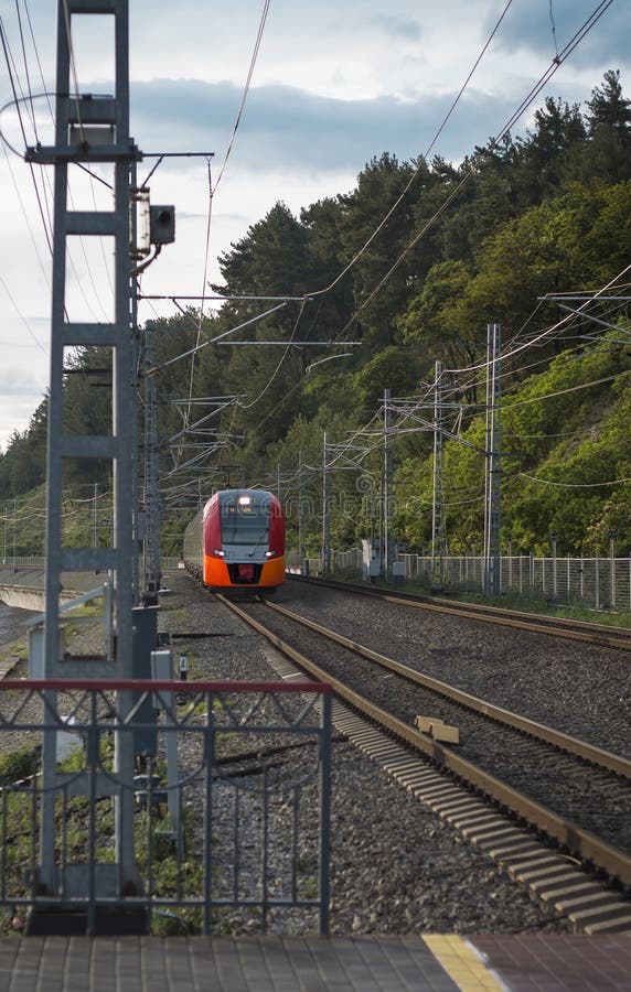 Passenger Train on the Railway Tracks Approaching the Station Stock ...