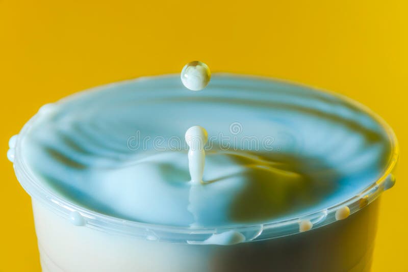 High Speed Photograph of a Milk Drop on Yellow Background in the Stock ...