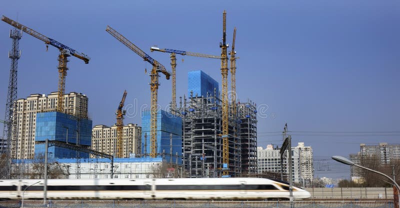 A High-speed Rail Train is Speeding Past a Large Infrastructure Site ...