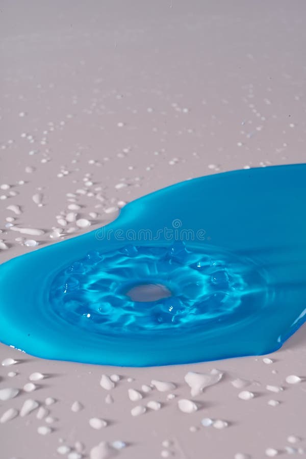 High-speed Shot of a Blue Water Splash on a Smooth Surface Stock Photo ...