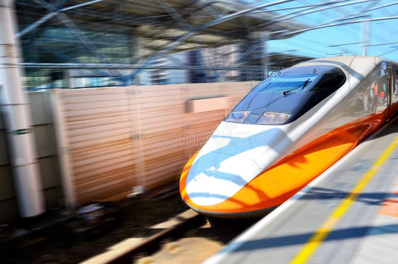 High Speed Orange Train In Motion On The Railway Station Stock Photo ...