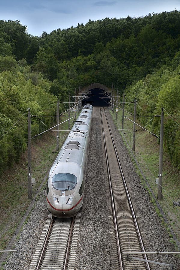 High-speed Train Exiting Forest Tunnel. Stock Photo - Image of forest ...