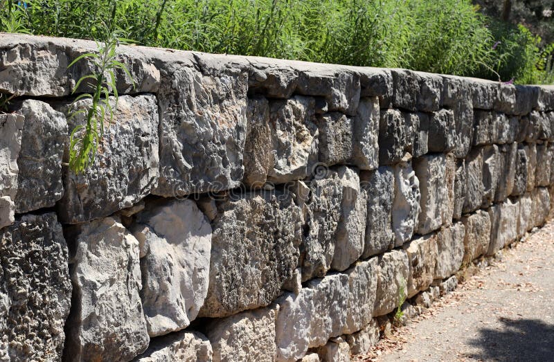 High Stone and Concrete Wall Stock Image - Image of concrete, stones ...