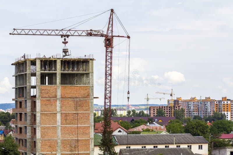 High Storey Building Under Construction with Tower Crane and Workers ...