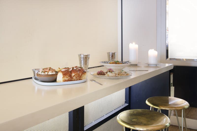 High Table of a Restaurant with Plates of Food and Stools with Golden ...