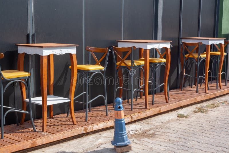 High Tables and Chairs Along the Wall Outside Stock Image - Image of ...