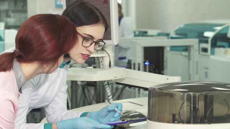 Two Female Biologists Collaborating on Experiments in a Modern Lab ...