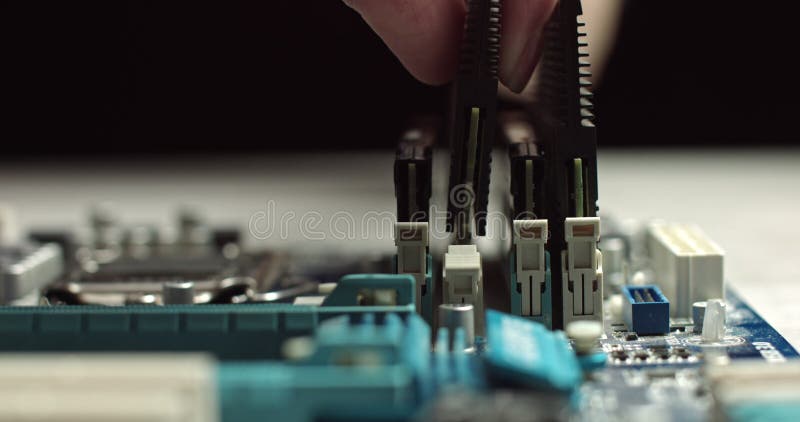 High Tech. the Process of Installing RAM on a Computer Motherboard ...