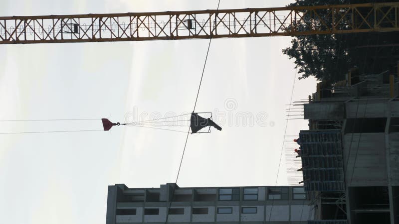 High Tower Crane Working on Construction Site Against Blue Sky ... High Tower Crane Working on Construction Site Against Blue Sky ...