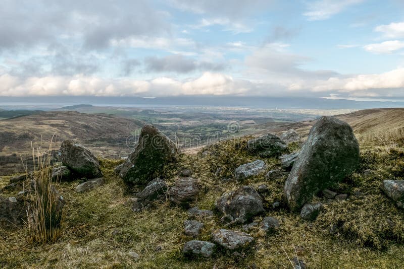 High Vantage Point. Collection of Dark Rocks on a Grassy Slope Stock ...