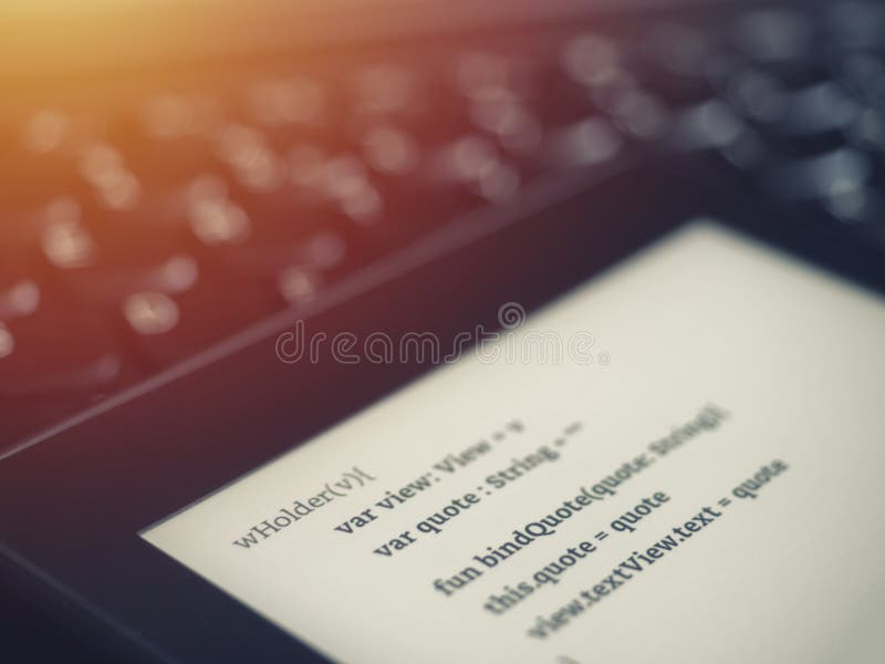 High View of a Ebook Reader with Programing Lessons on a Laptop ...