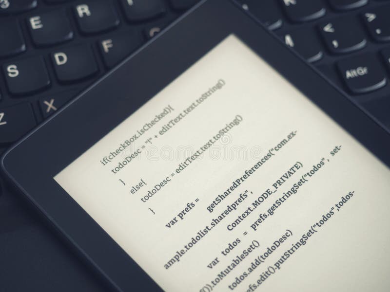 High View of a Ebook Reader with Programing Lessons on a Laptop ...