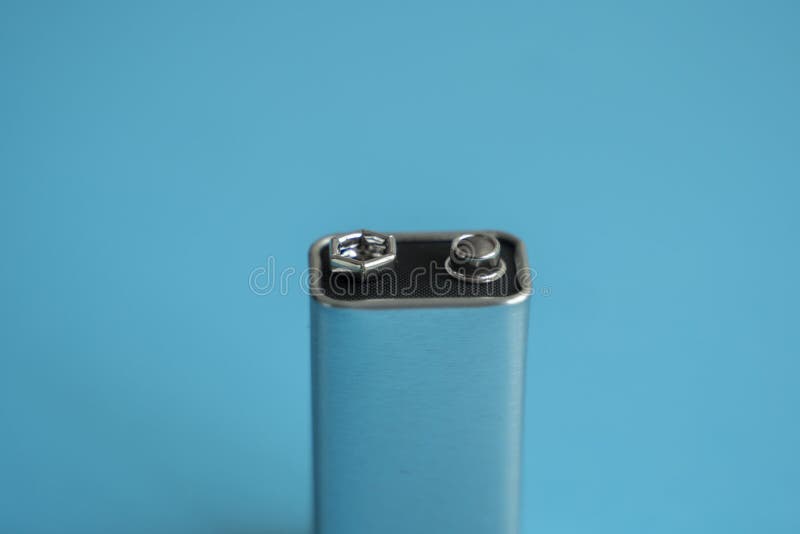 High Voltage Battery on a Blue Background. Silver Volt Battery. 9V ...