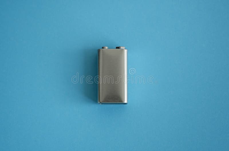 High Voltage Battery on a Blue Background. Silver Volt Battery. 9V ...