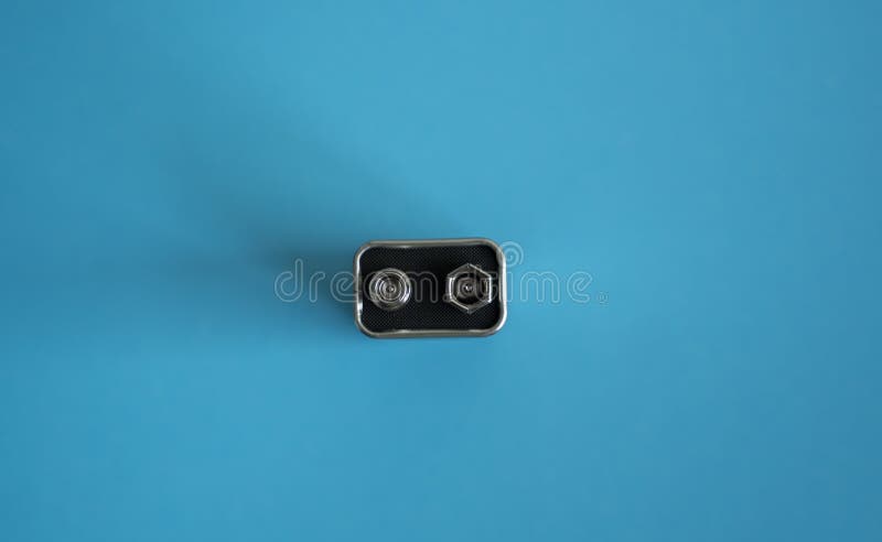 High Voltage Battery on a Blue Background. Silver Volt Battery. 9V ...