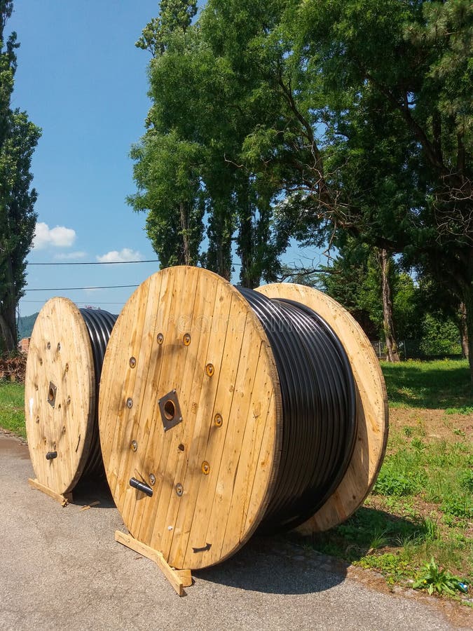High Voltage Black Electrical Cable Rolled on Large Cable Reels Stock ...