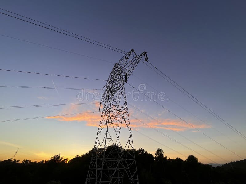 High Voltage Cable Tower during Sunset on a Mountain Stock Photo ...